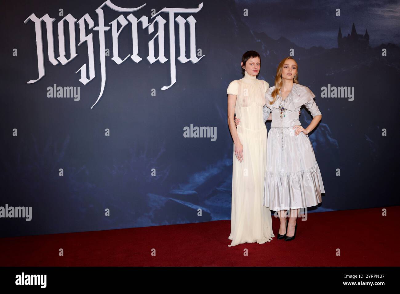 Emma Corrin, left, and Lily-Rose Depp pose for photographers upon ...