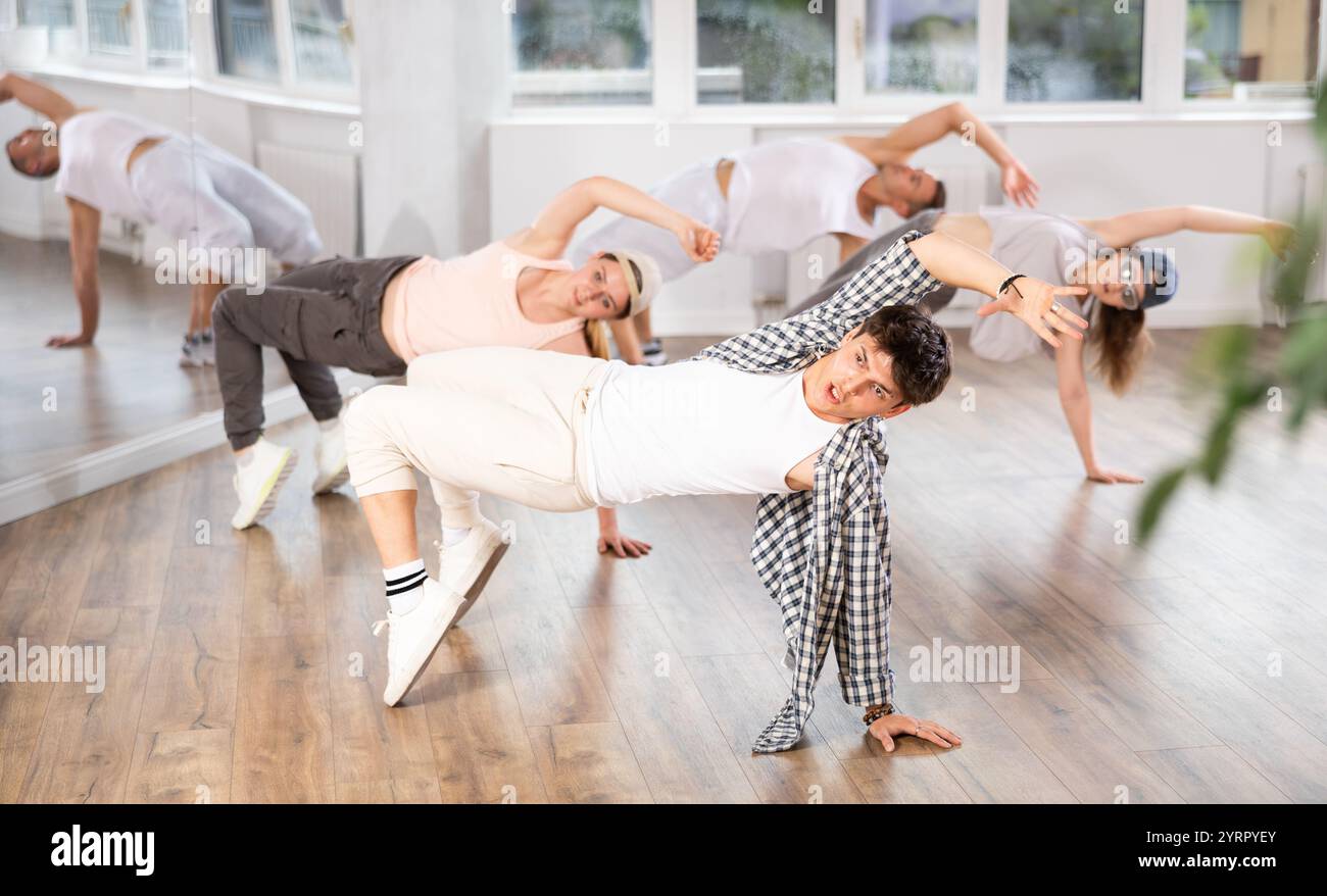 Young guy practicing breakdance in training hall Stock Photo - Alamy