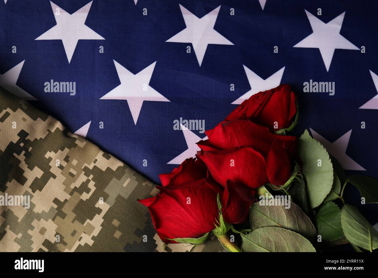 Veterans day. Rose flowers and military uniform on American flag, flat ...