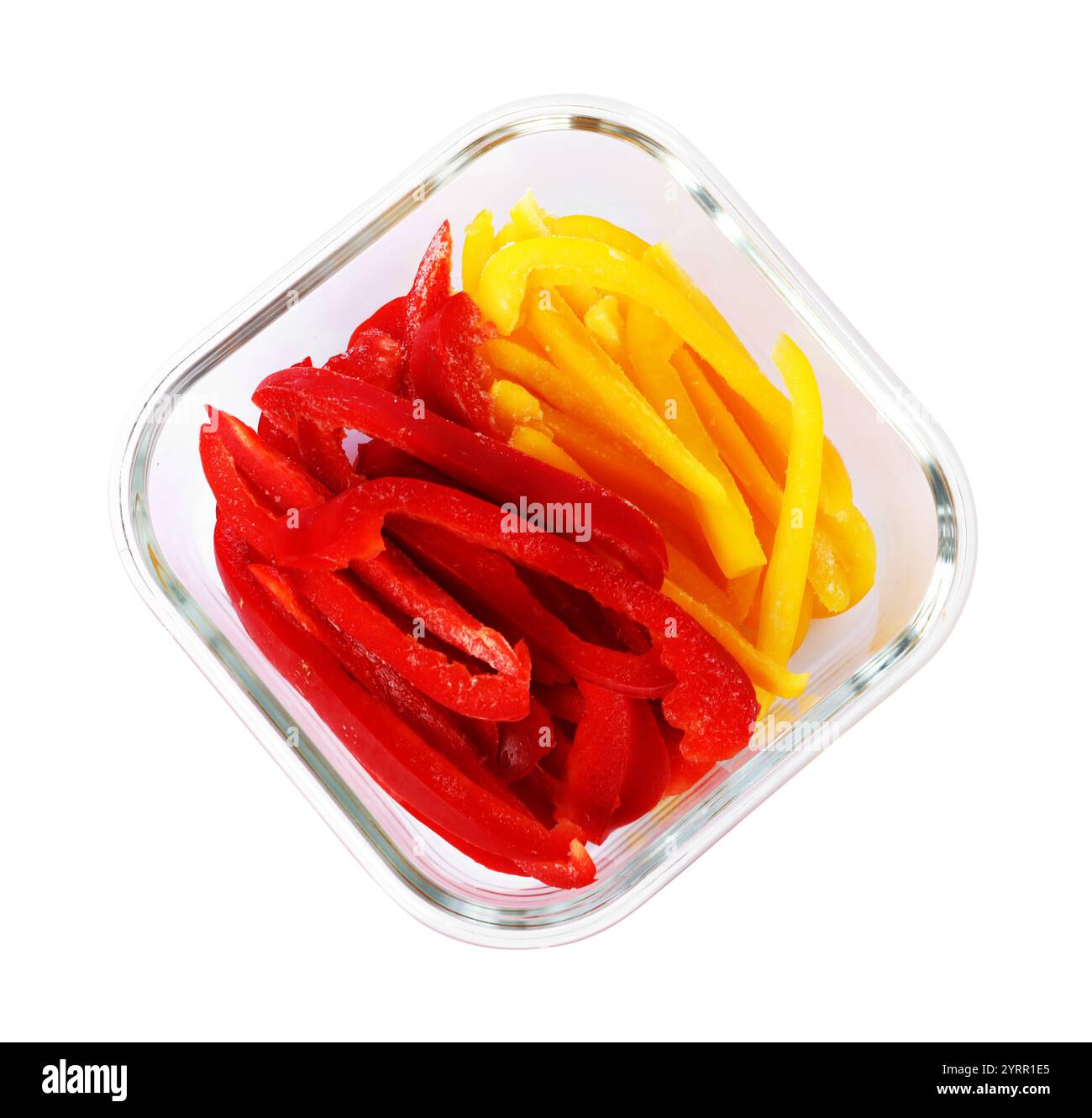 Pieces of frozen bell peppers in container isolated on white, top view ...
