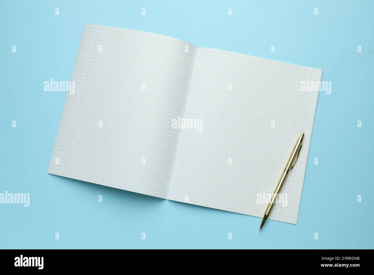 Open copybook and pen on light blue background, top view Stock Photo ...
