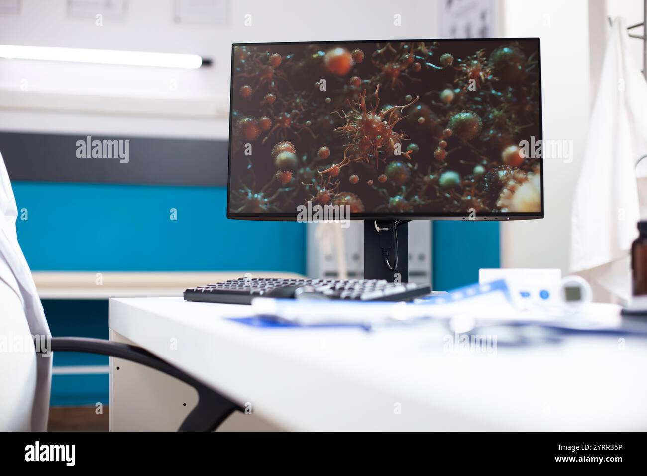 Doctors office with an unoccupied table and desktop pc screen showing ...