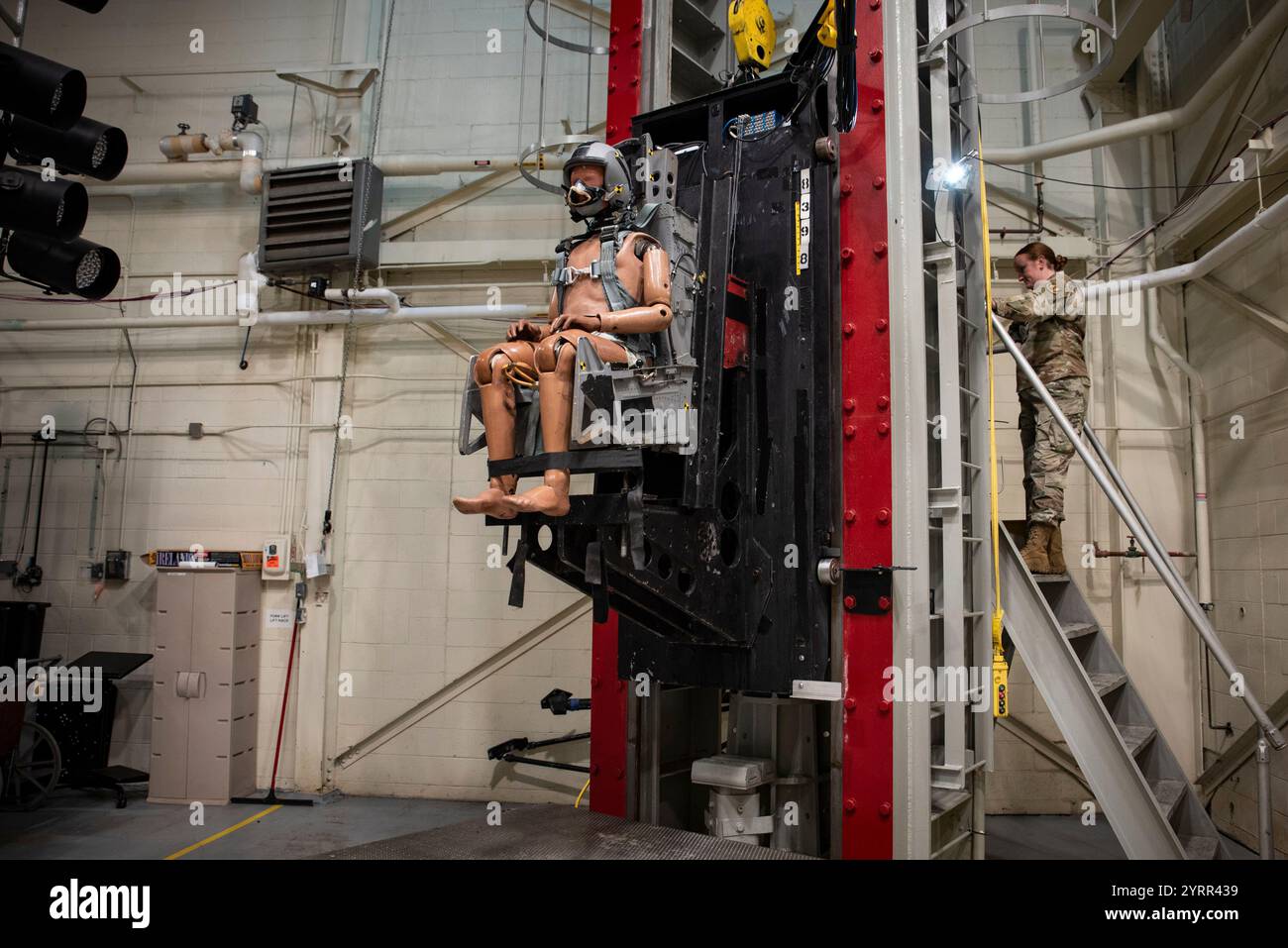 An Anthropomorphic Test Device is hoisted by Staff Sgt. Tanya Stewart ...