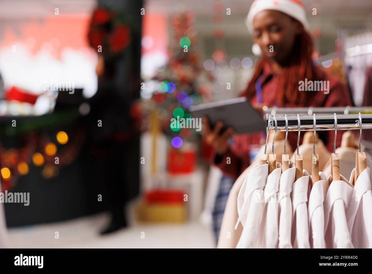 Employee checking clothing price tags hi-res stock photography and ...