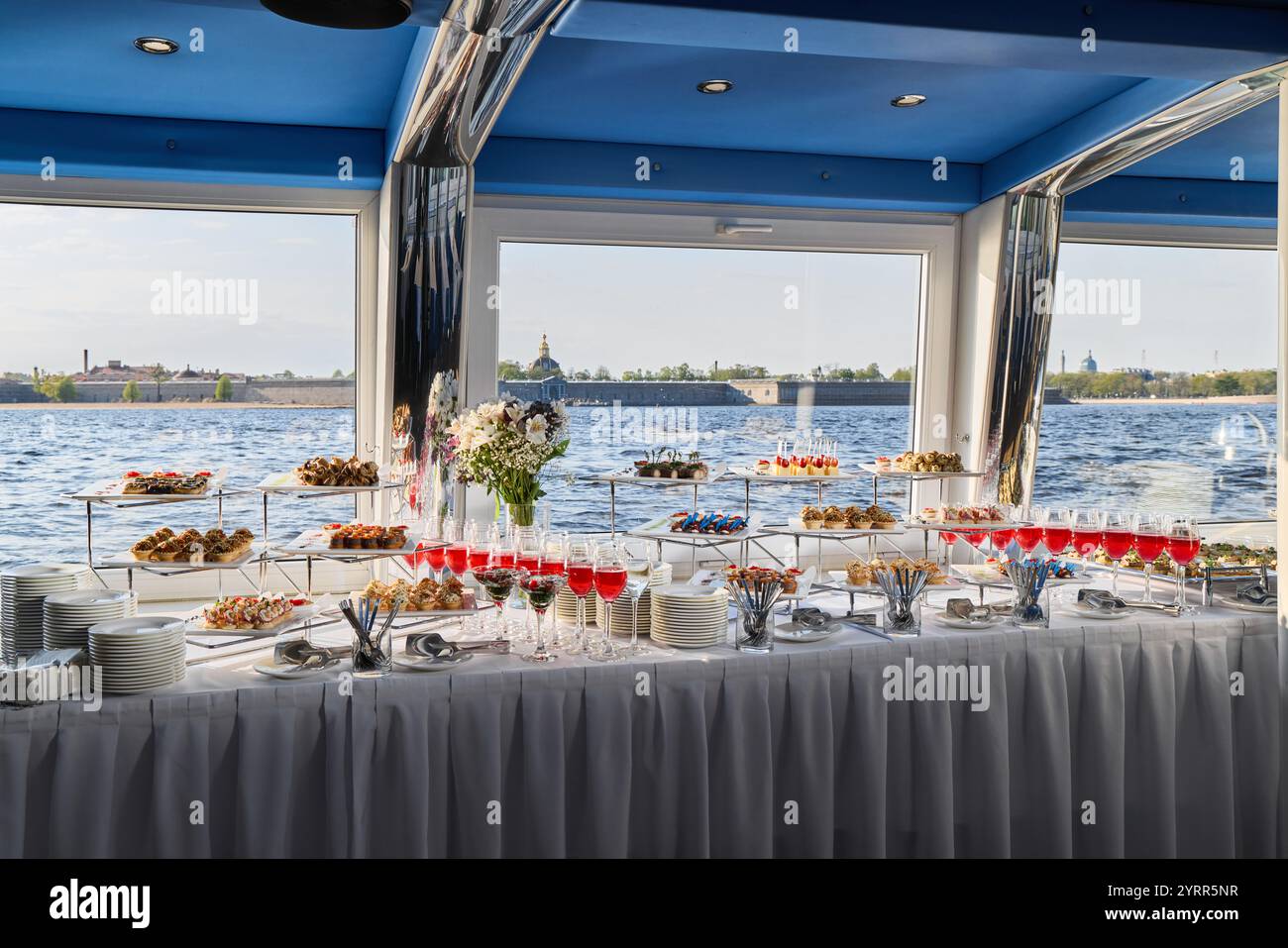 An Elegant Buffet Setup Featuring a Scenic Waterfront View for Your ...