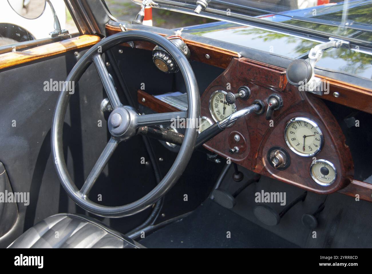 Interior view of a classic car with classic steering wheel and a wooden ...