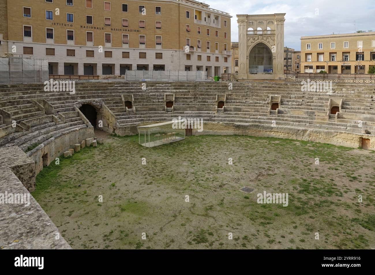 An ancient Roman amphitheatre made of stone with grass inside ...