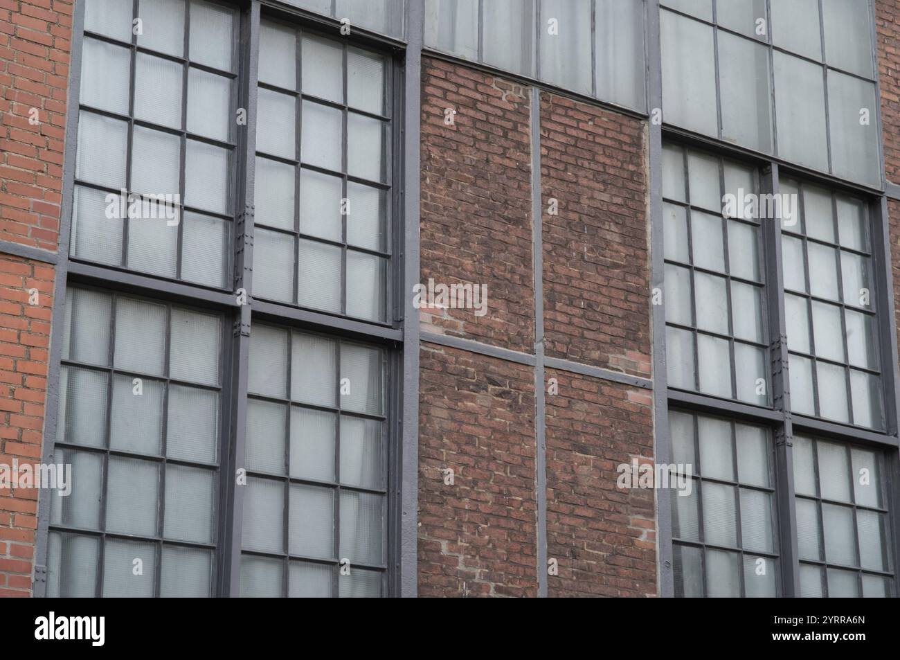 Large windows and brick walls combine in a modern architectural design ...