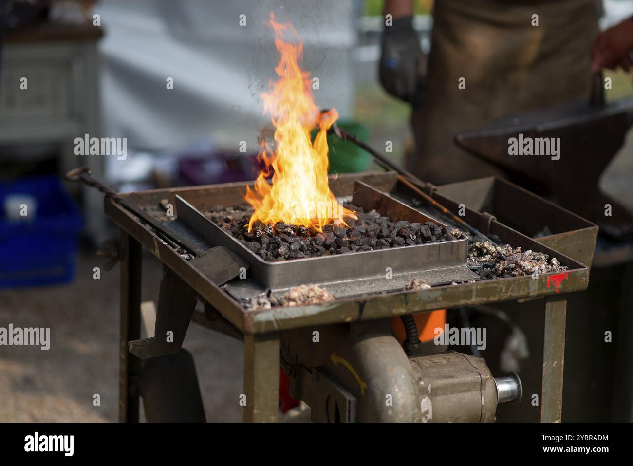 Blacksmith stokes the fire Stock Photo - Alamy
