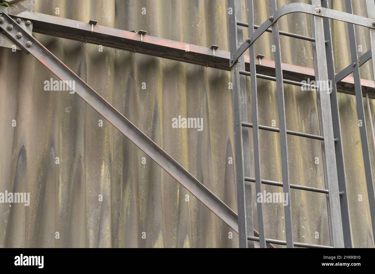 Close-up of a metal ladder and support beam attached to a corrugated ...