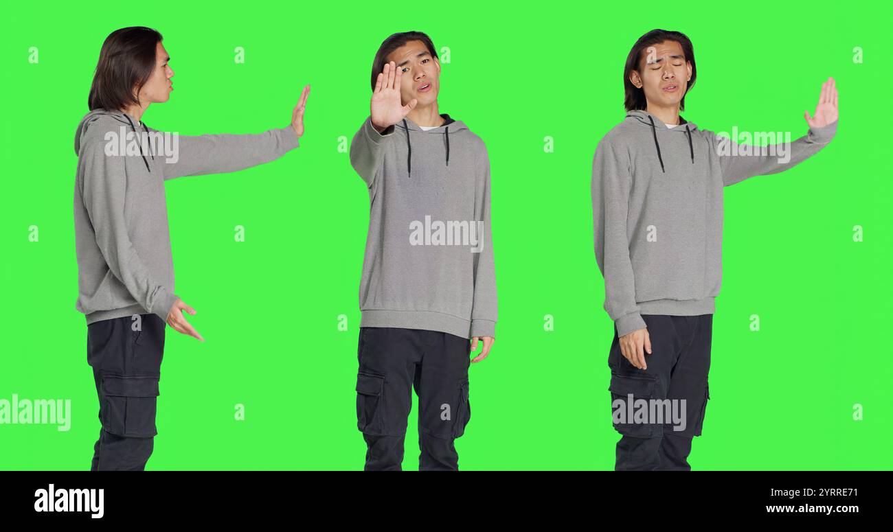 Model showing stop sign with palm in studio with greenscreen background ...