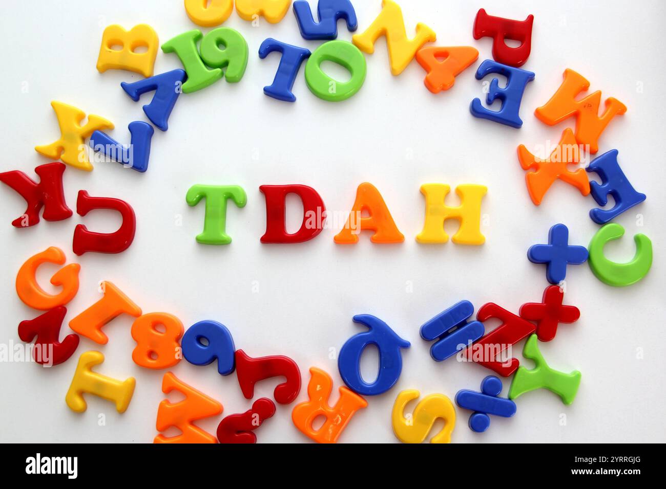Colored toy letters for children form the word TDAH which means ...