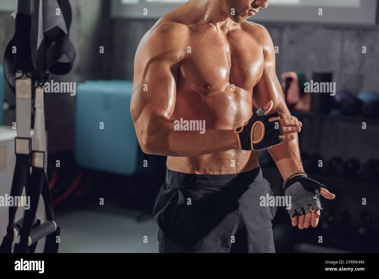 A fit and determined man is preparing himself for an intense workout ...