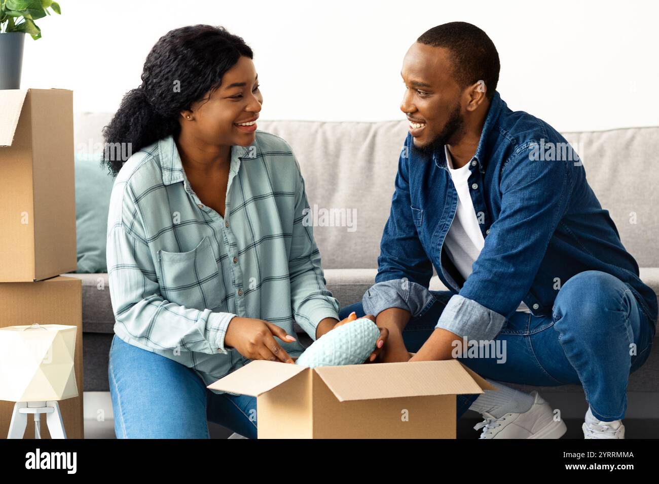 Moving To New House. Happy African-American Spouses Packing Belongings ...