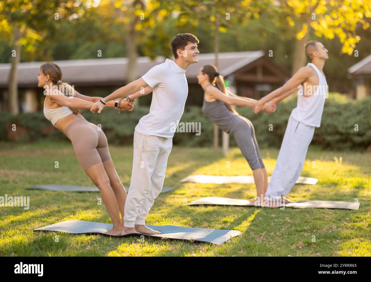 Guy and girl practice pair yoga doing Backbend Balance pose asana Stock ...