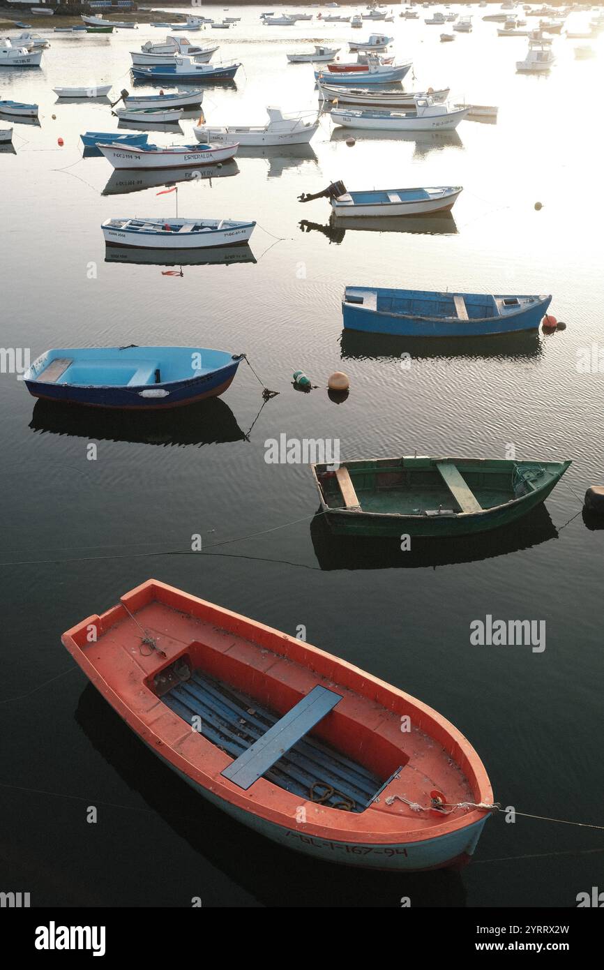 Colorful fishing boats floating peacefully in calm harbor waters at ...