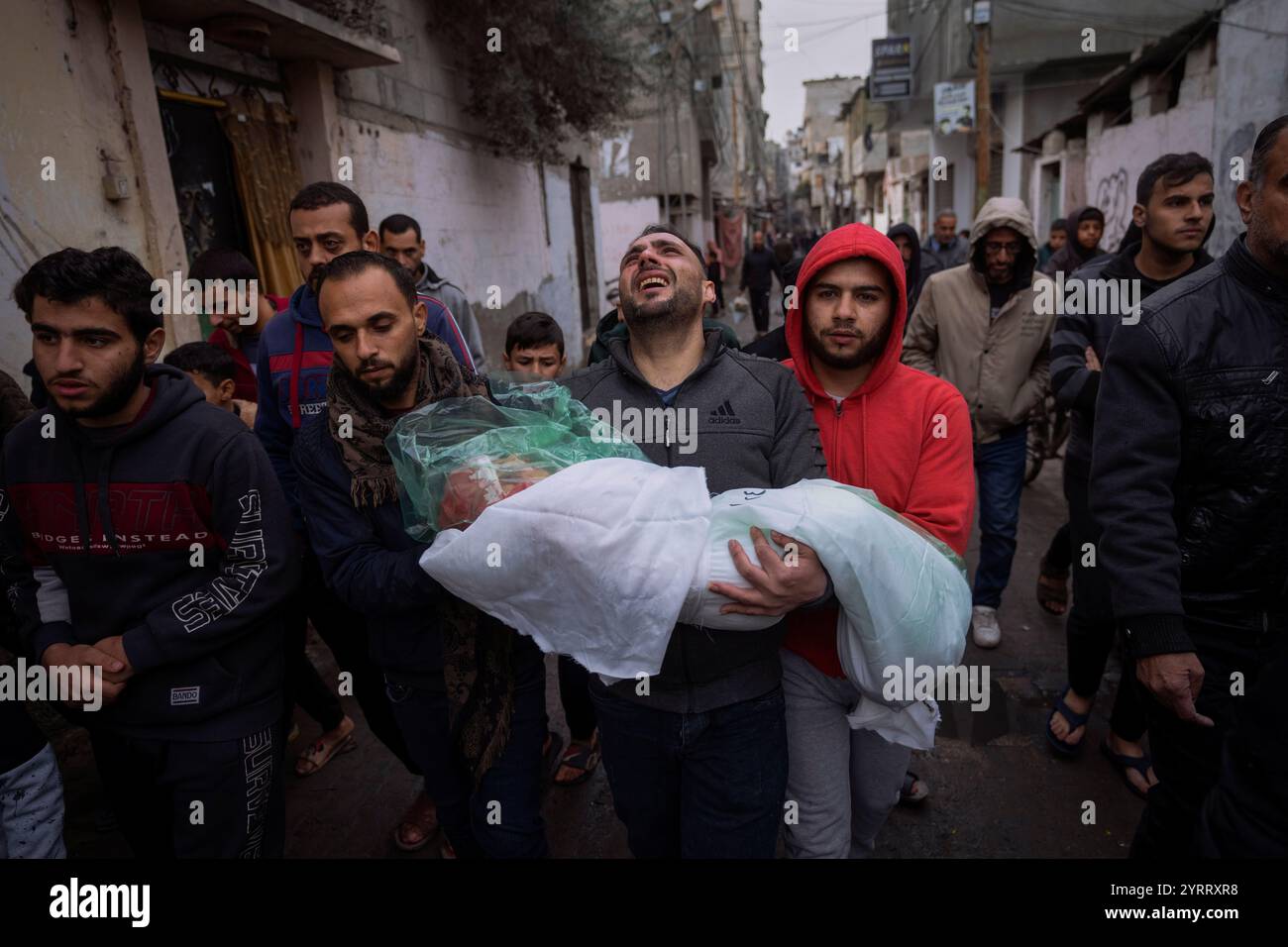 FILE - Mohammad Shouman carries the body of his daughter, Masa, who was ...