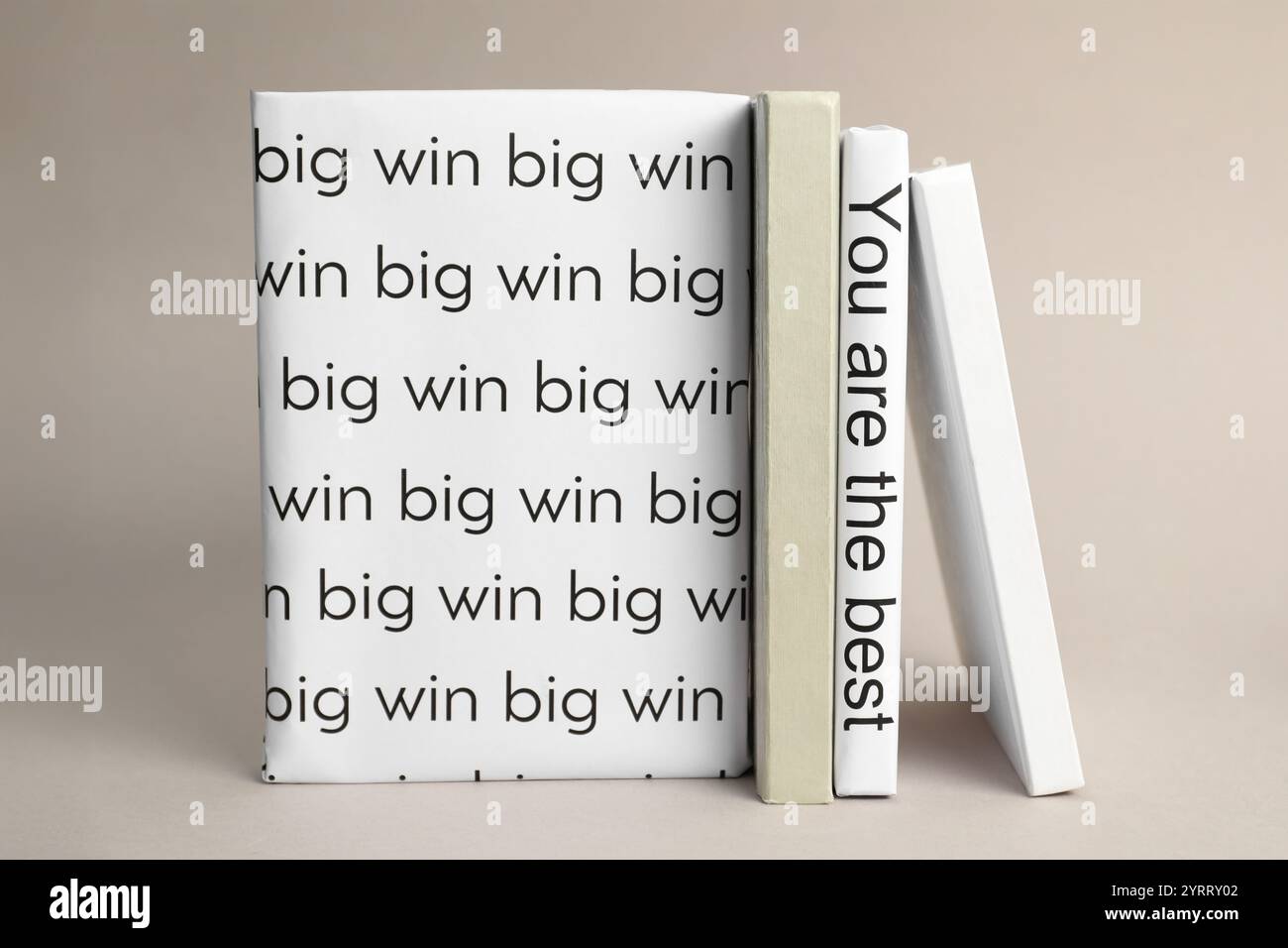 White books with phrases You are the best and Big win between ones on ...