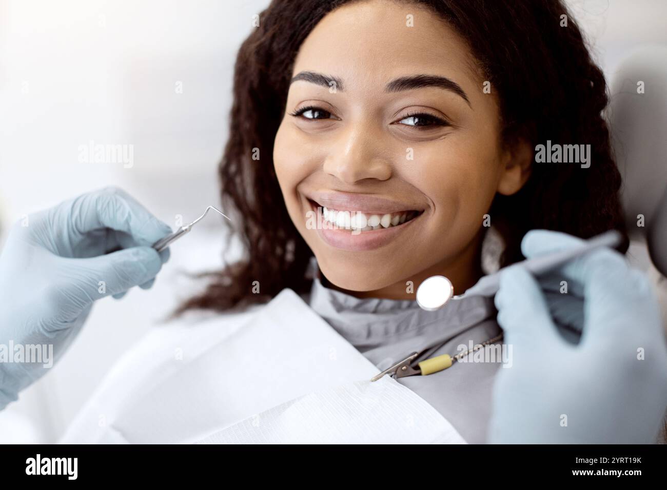 Portrait Of Smiling Black Female Patient Having Dental Treatment With ...