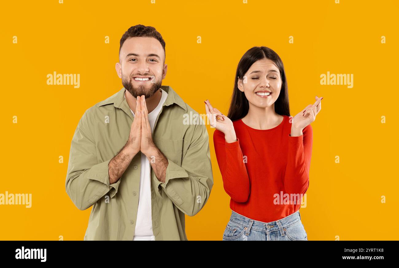 Couple expressing joy and affection in front of a vibrant yellow ...