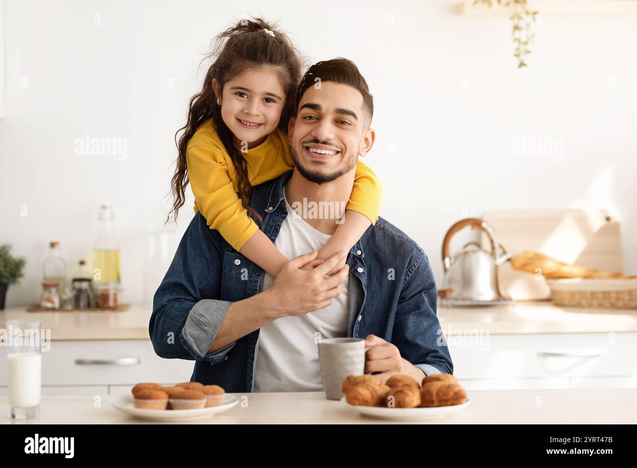 Happy Middle Estern Father And Daughter Posing In Kitchen While Eating ...