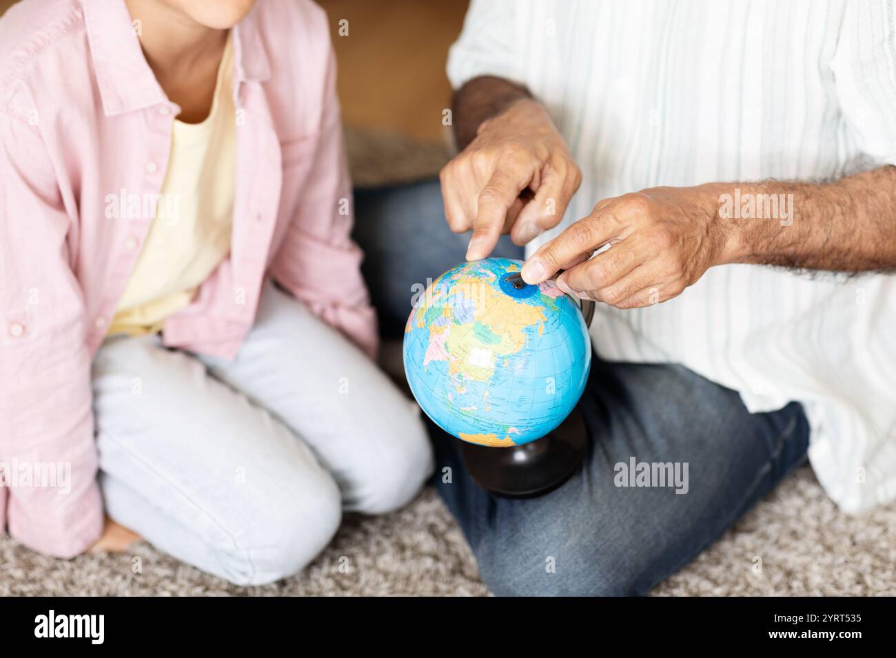 Grandfather and grandson bonding over globes in cozy family setting ...