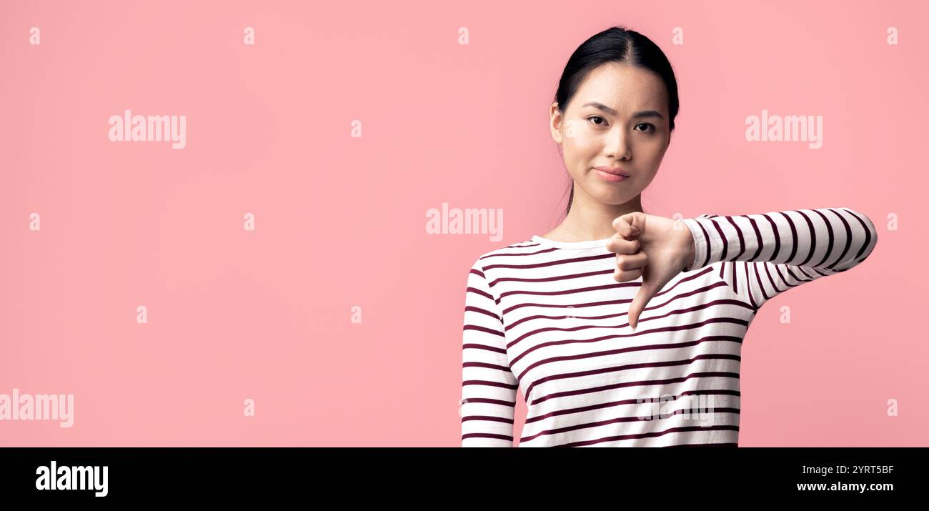 Disappointed korean woman showing thumb hi-res stock photography and ...