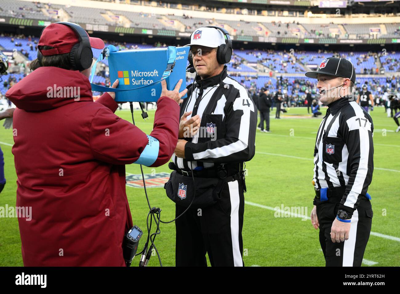 NFL referee Craig Wrolstad (4) tests out the replay mechanism next to ...