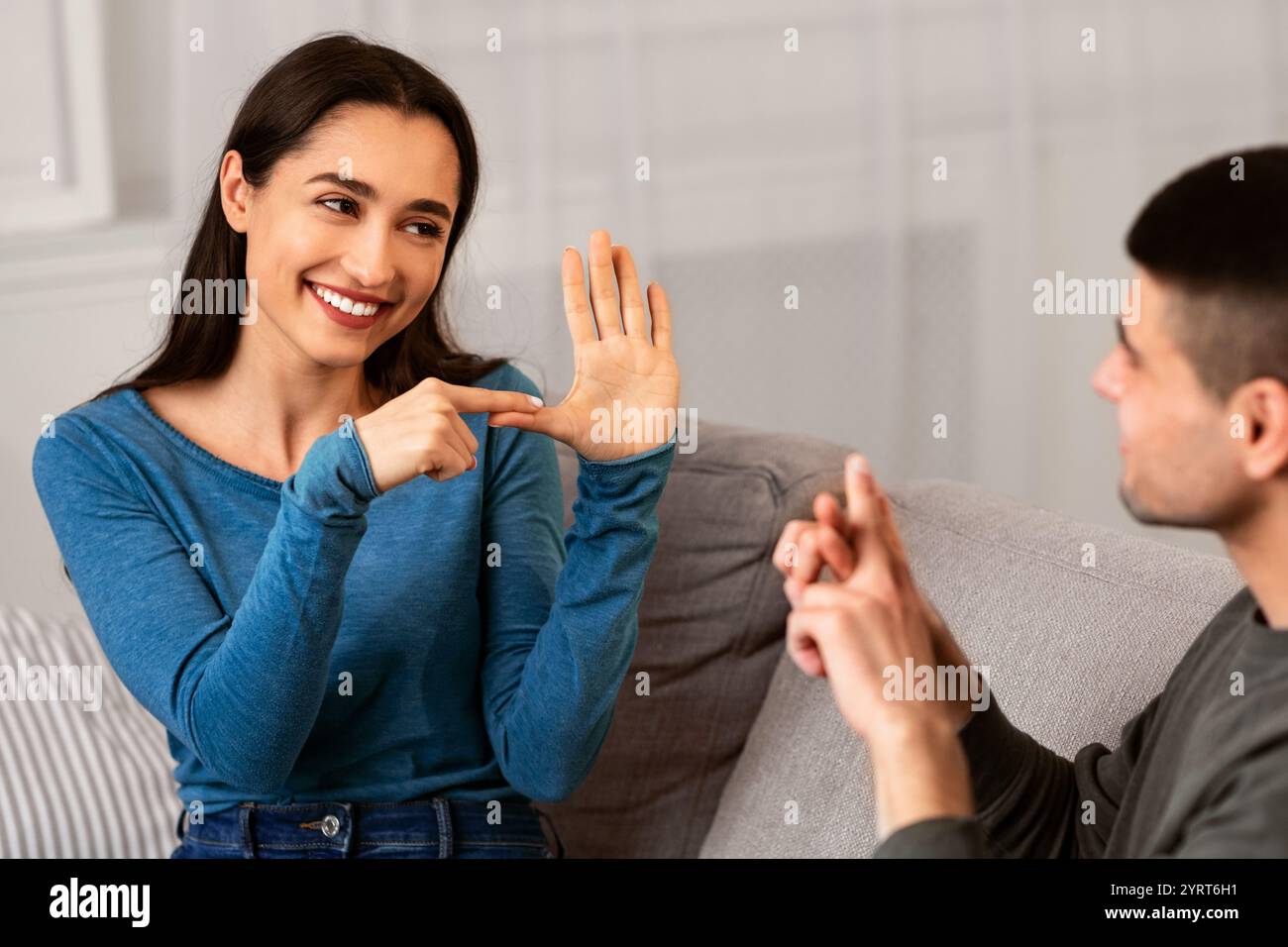 Couple Sitting On Sofa Communicating With Sign Language Stock Photo - Alamy