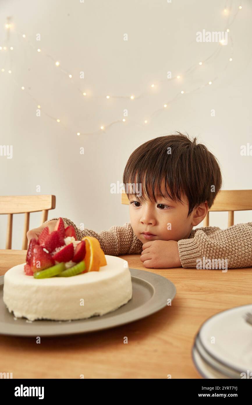 Boy looking birthday cake hi-res stock photography and images - Alamy