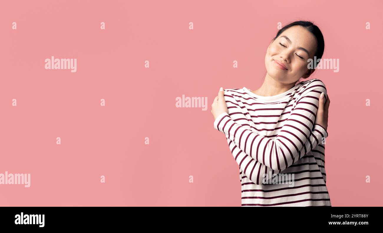Love Yourself Concept. Pleased Young Asian Woman Embracing Herself ...