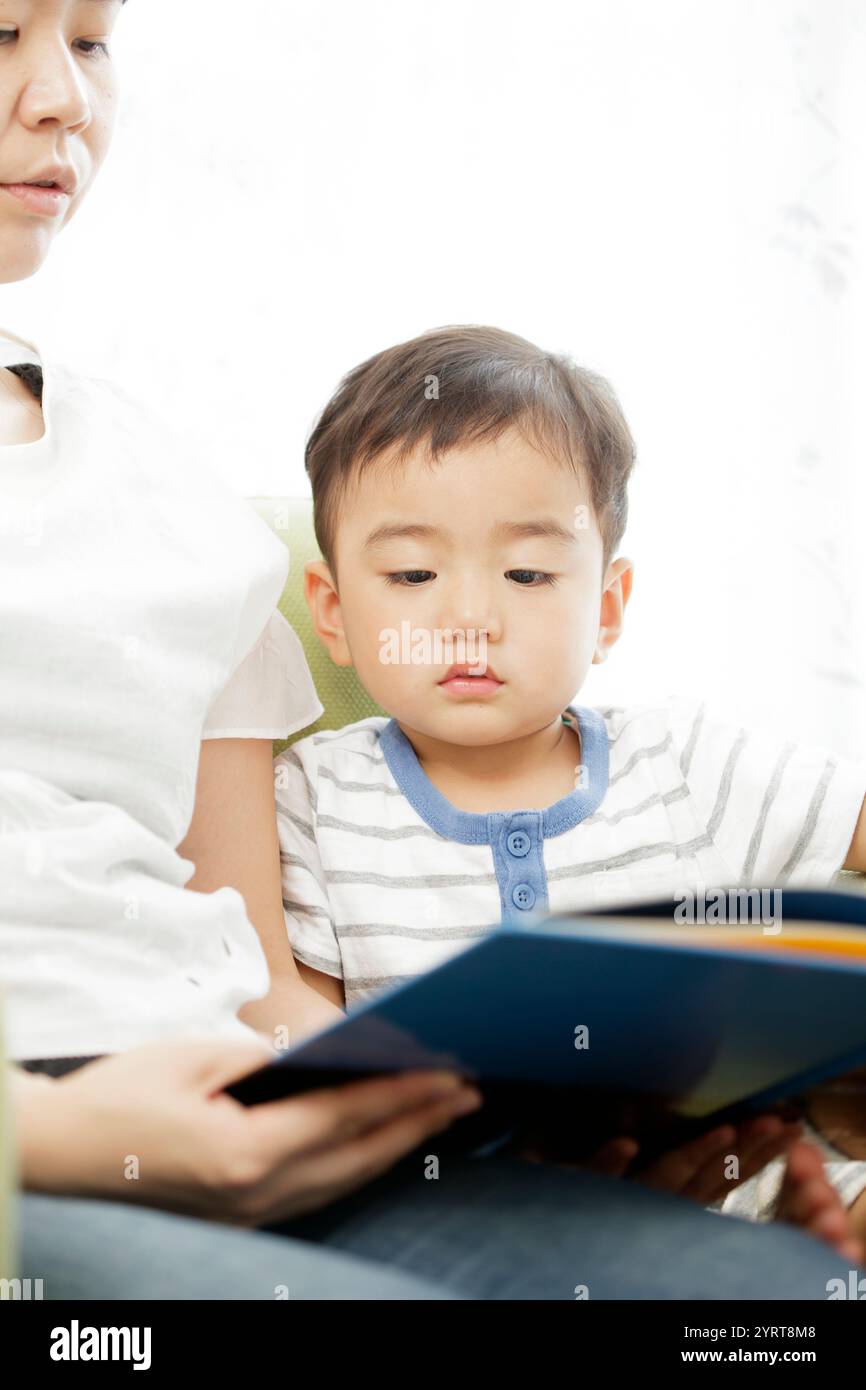 A boy reading a picture book Stock Photo - Alamy