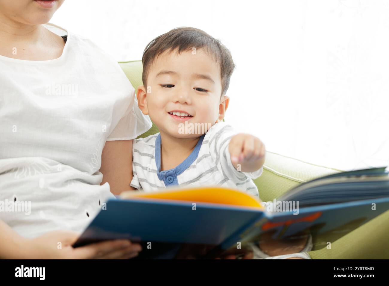 A boy reading a picture book Stock Photo - Alamy