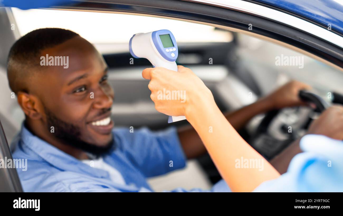 Medical Worker Checking Body Temperature Of Black Man In Car Stock ...