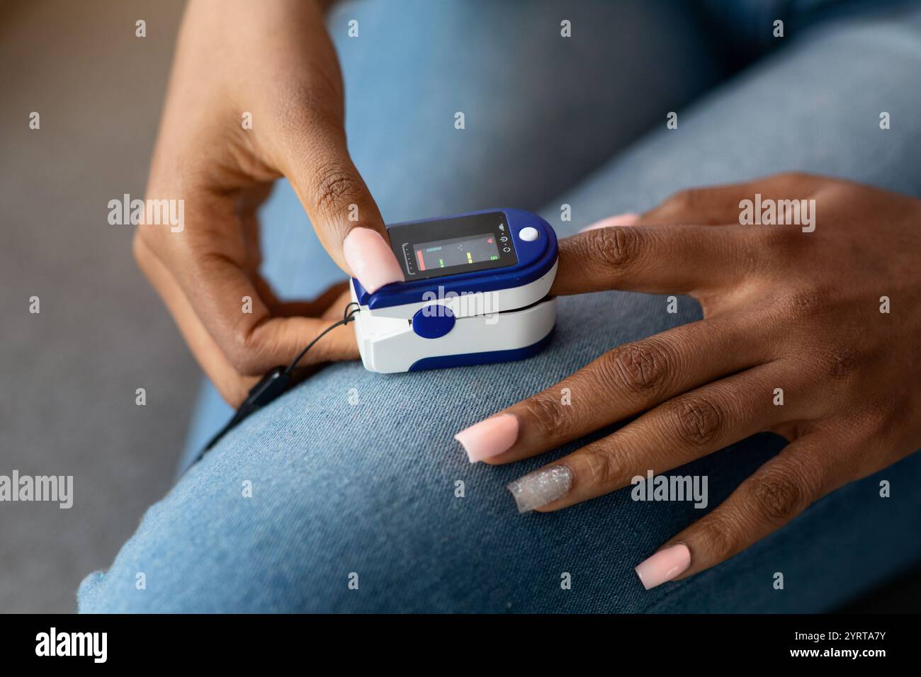 Unrecognizable African American Woman Using Oximeter At Home, Checking ...