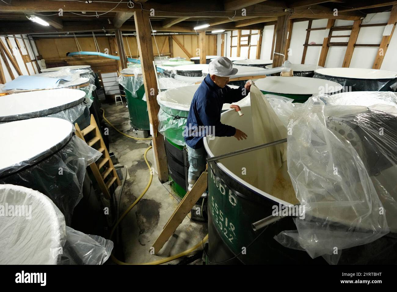Seasonal employee Daichi Ushiyama adds rice with koji mold to other ...