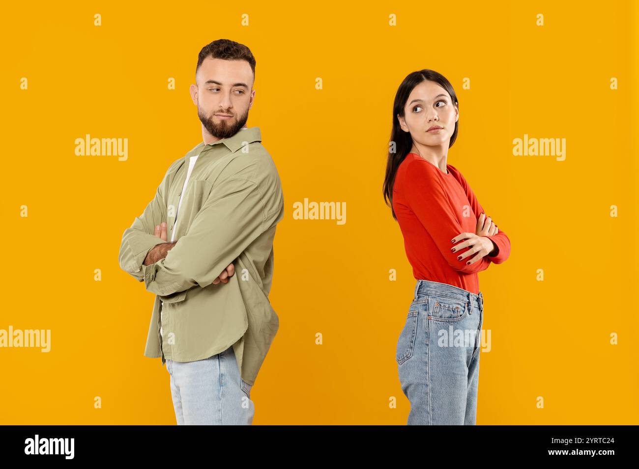 Couple back to back showing contrasting emotions with a bright backdrop ...