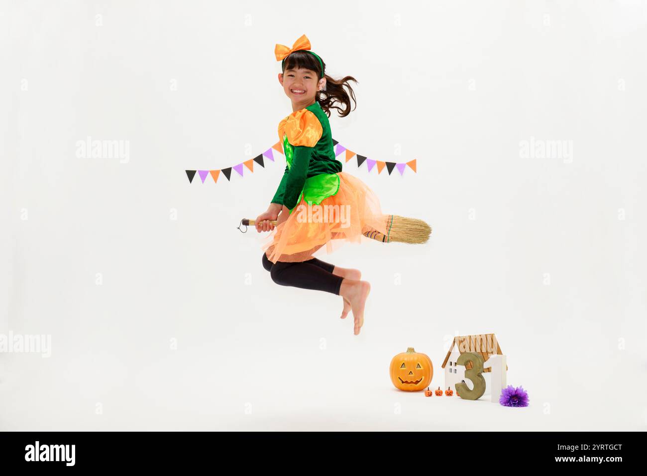 A girl jumping in a Halloween costume Stock Photo - Alamy