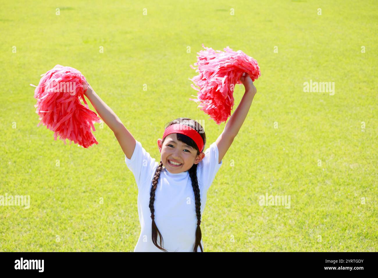 A girl cheering on the grass Stock Photo - Alamy