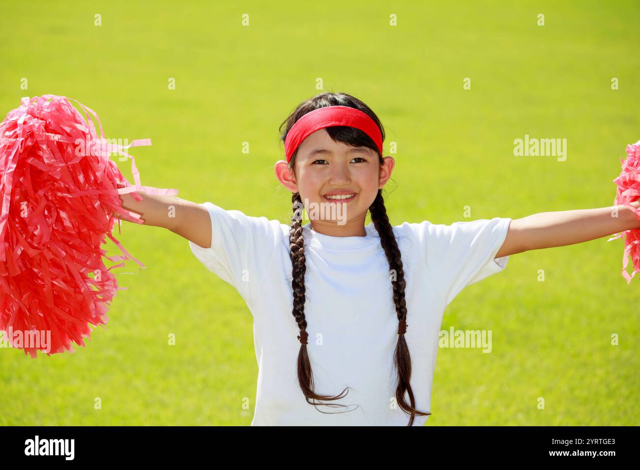 A girl cheering on the grass Stock Photo - Alamy