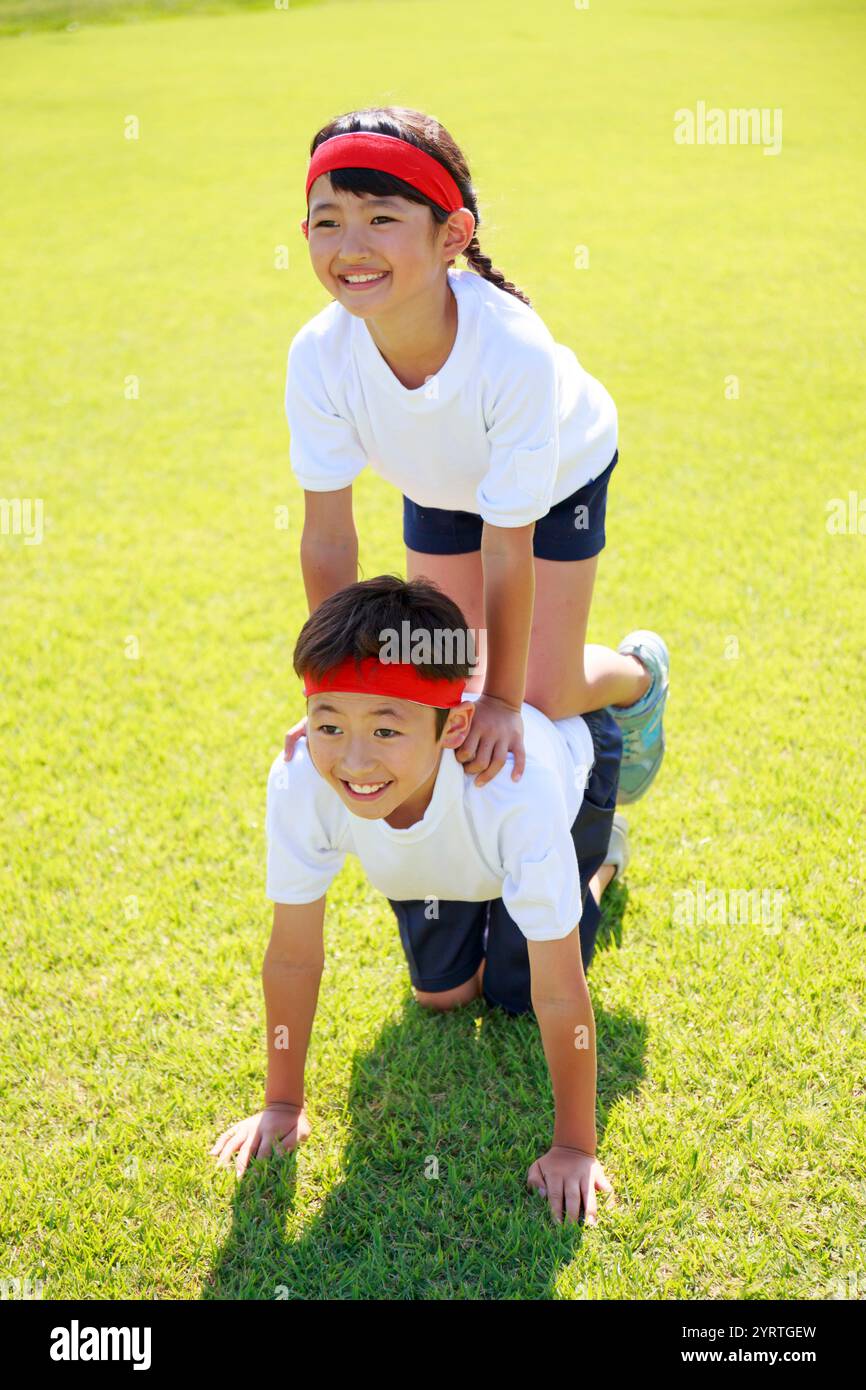 Children practicing group gymnastics in gym clothes Stock Photo - Alamy
