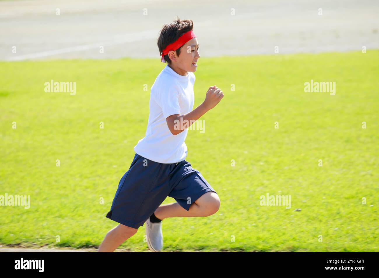 A boy running in gym clothes Stock Photo - Alamy