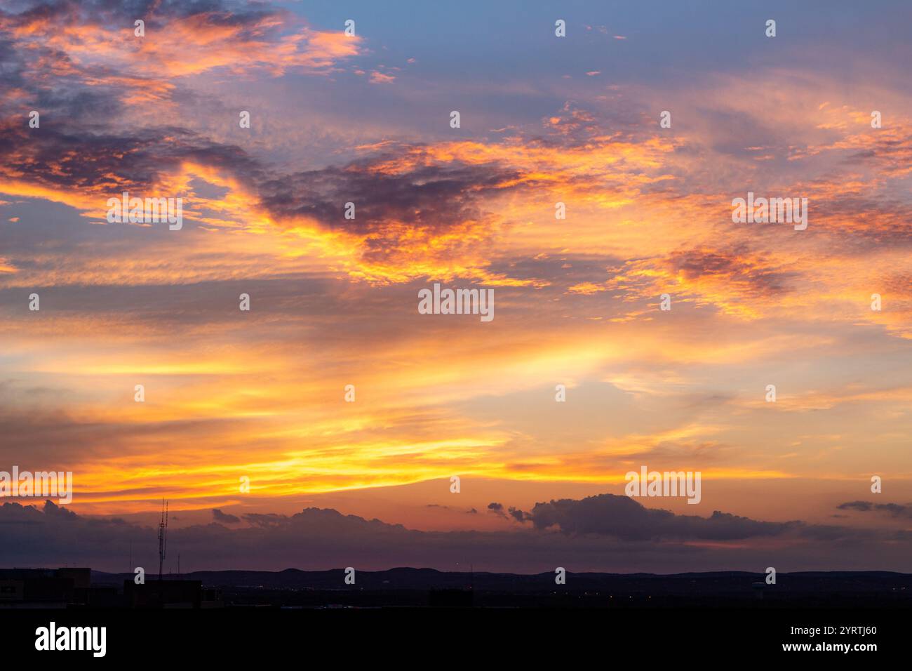 Orange dramatic and colorful sky over a horizon. Photo was taken of the ...