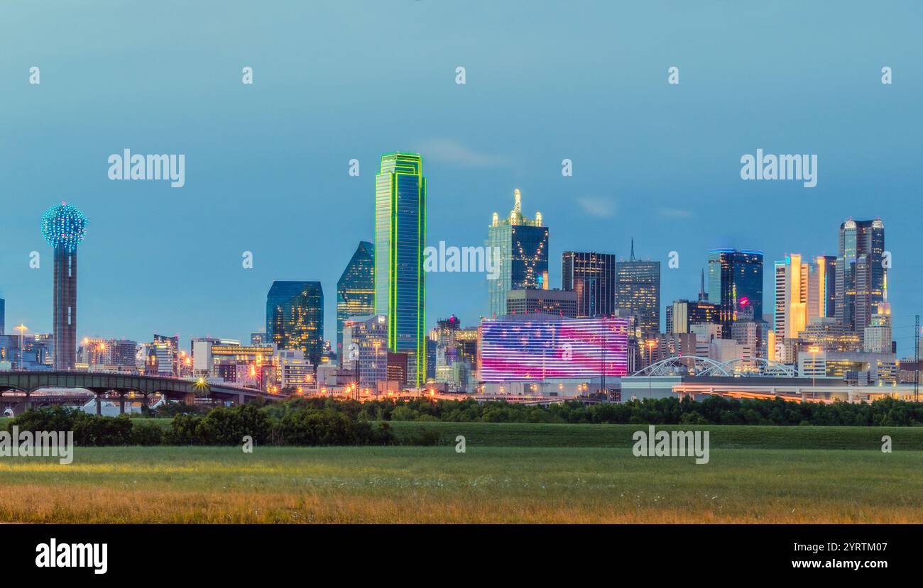 Colorful downtown Dallas Texas city skyline on a cloudy blue evening ...