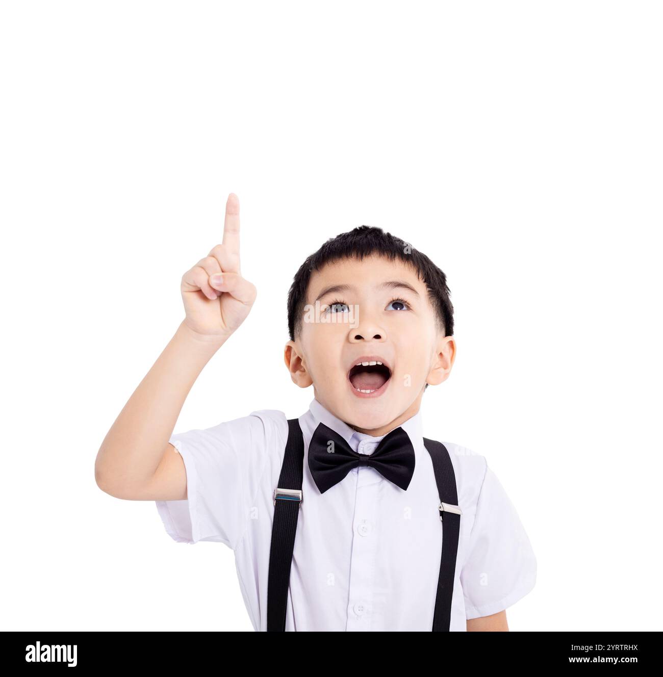 Portrait of amazed cute school boy pointing to empty place on white ...