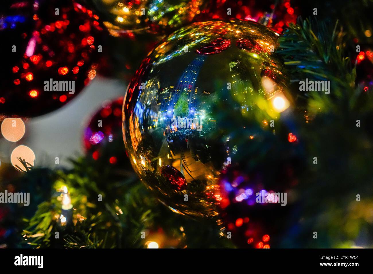 The Rockefeller Center Christmas tree reflects in an ornament during ...