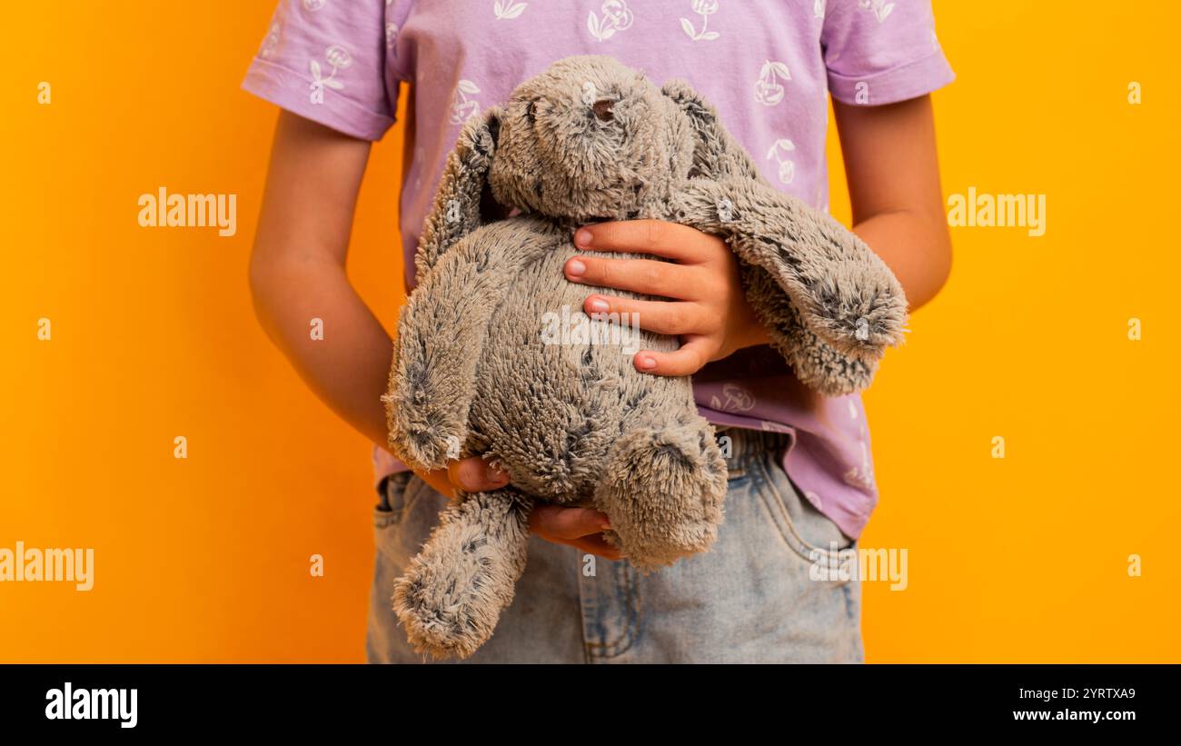 Kid with plush toy. Bunny toy in hand. Easter bunny toy. Bunny ears and ...