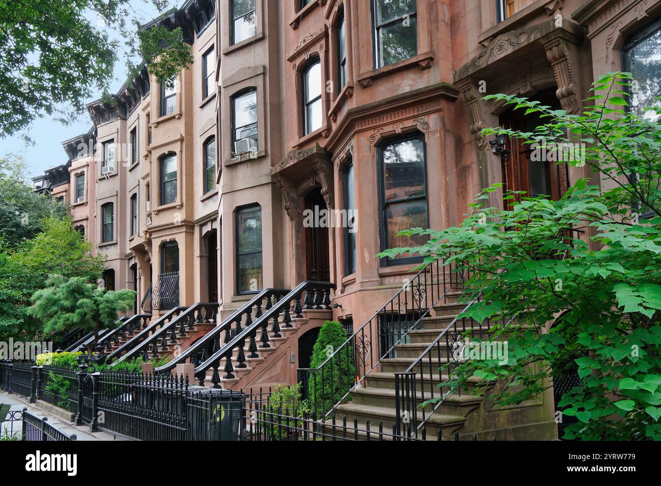 Long row of old brownstone buildings in New York City Stock Photo - Alamy