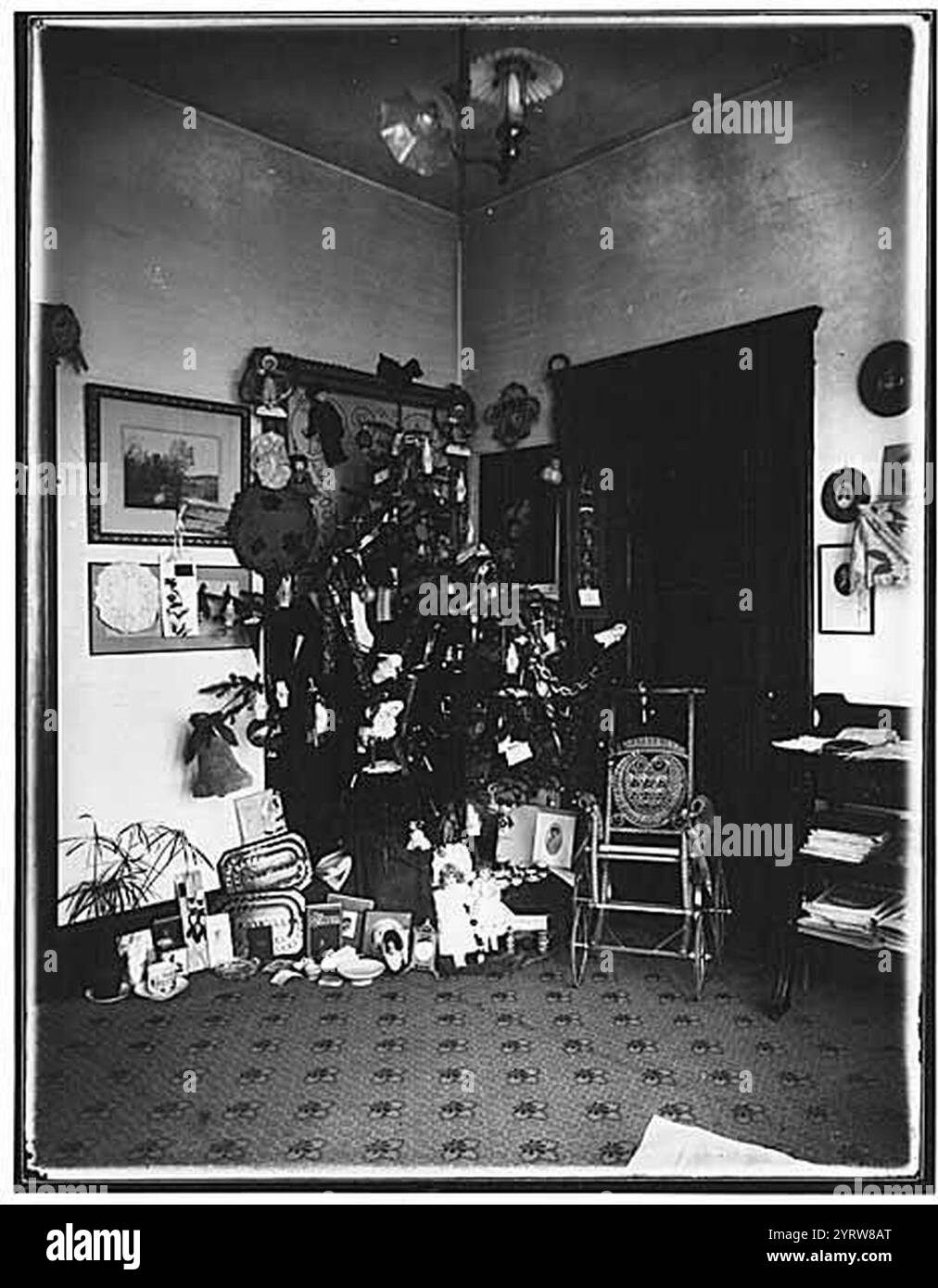 Christmas tree in corner of Warner family parlor with books, dolls, tea ...