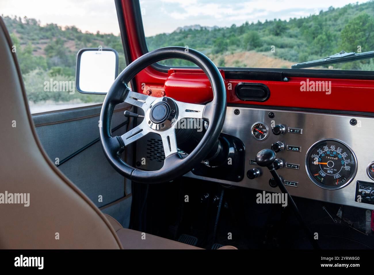 Classic Jeep CJ-5 interior with a scenic backdrop in late afternoon ...